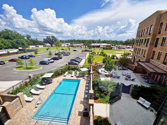 A sparkling pool next to historic brick architecture proves you can have both old-world charm and modern comfort.
