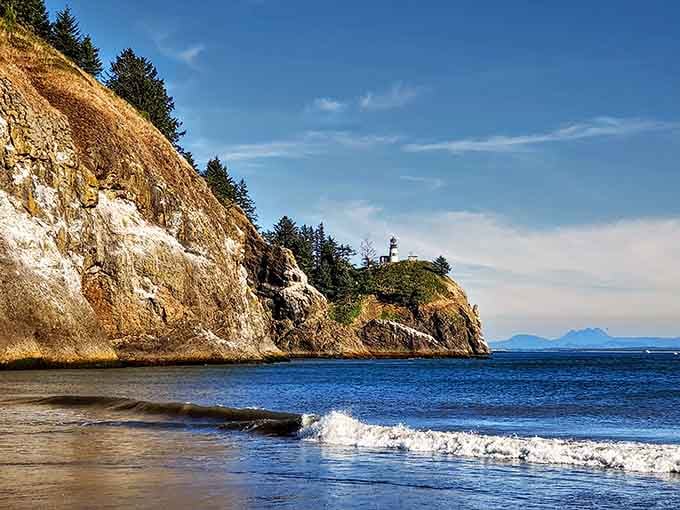 The lighthouse perched on those golden cliffs watches over waters where two mighty forces meet and dance.