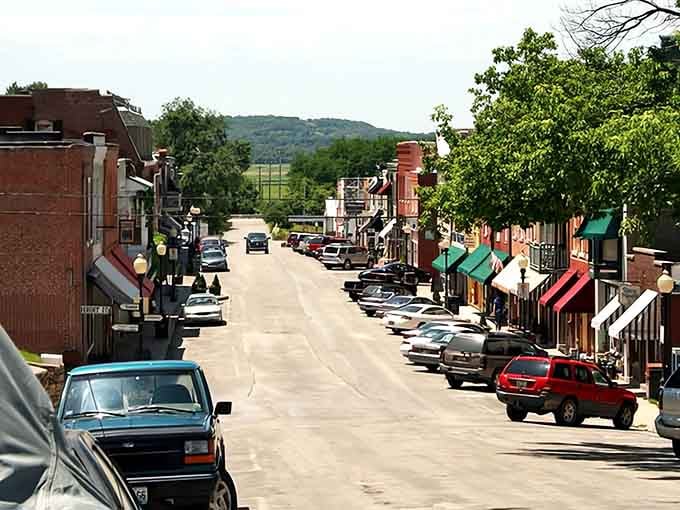 Main Street slopes gently toward rolling hills, framed by awnings that provide shade for window shoppers below.