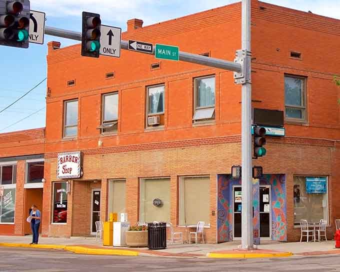 That orange brick glow hits different when there's a real barber shop on the corner&mdash;small-town America, still spinning.