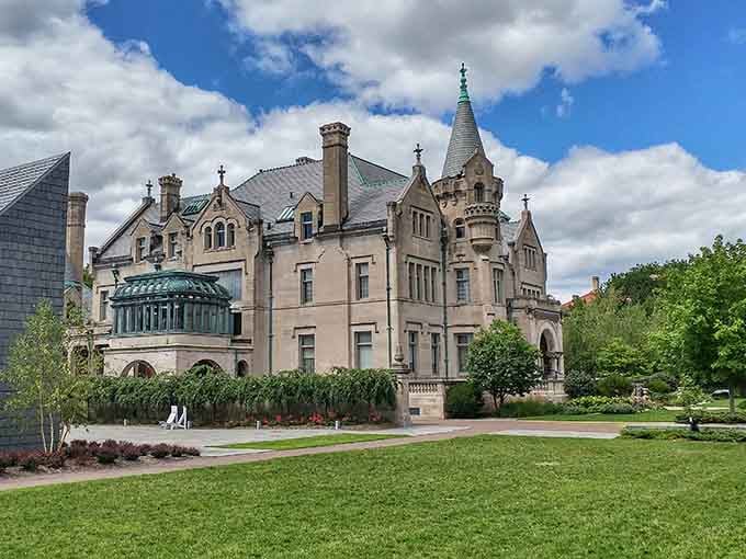 Dramatic clouds frame the mansion's ornate architecture, where every detail whispers stories of elegant bygone eras and grand celebrations.