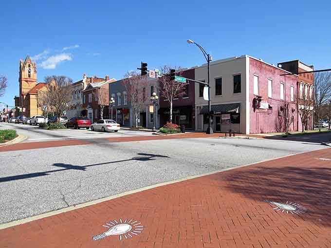 Decorative brick patterns in the crosswalk show someone here cares about details, even underfoot where most folks don't look.