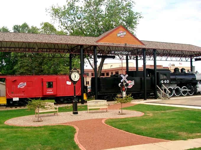 That vintage locomotive and bright red caboose sit perfectly preserved, honoring the iron horses that built these towns.