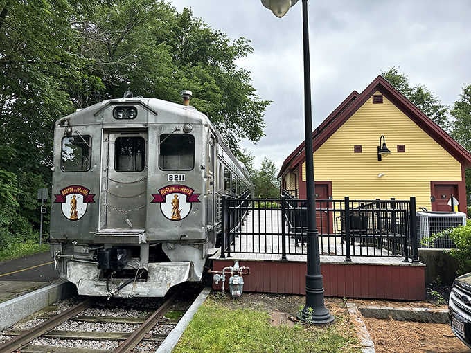 The old station house stands proud while its aluminum passenger car gleams, both witnesses to transportation's golden age.