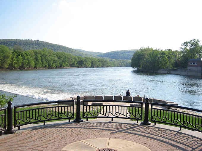 Binghamton's riverside overlook offers peaceful water views framed by green hills, proving scenic retirement spots don't require coastal property taxes.