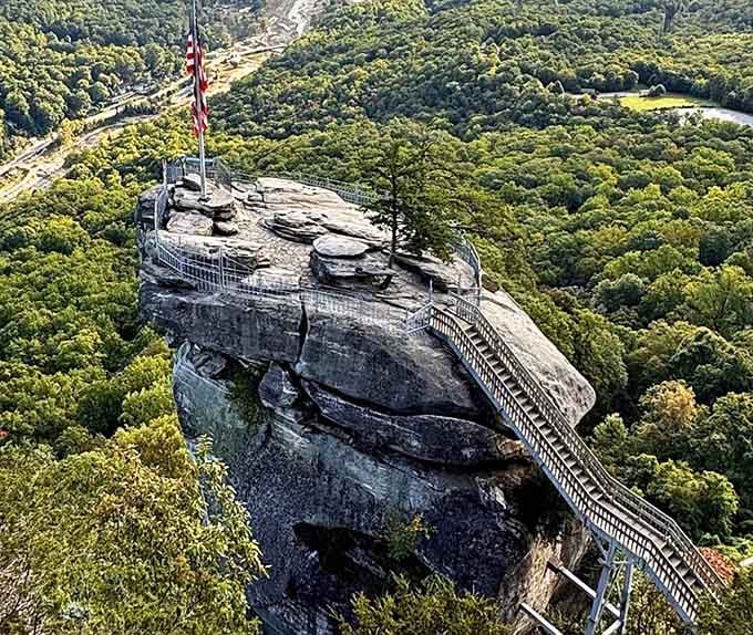 The aerial view reveals just how dramatically this stone platform juts out over the endless forest below.