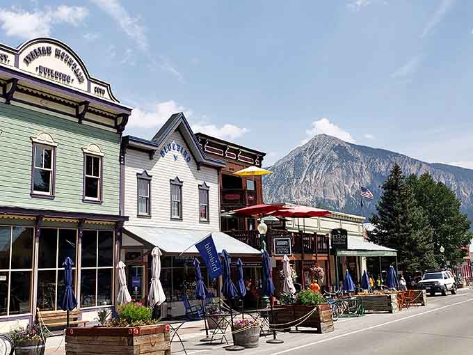 Victorian buildings painted in cheerful colors line streets where mountains steal the show at every turn.
