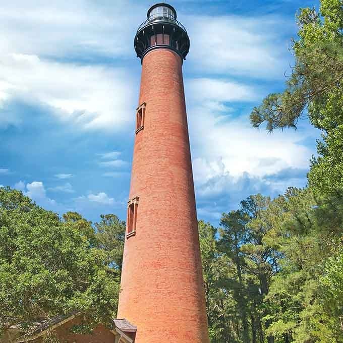 Surrounded by emerald canopy, Currituck's natural brick facade glows like autumn leaves against the Carolina blue sky.