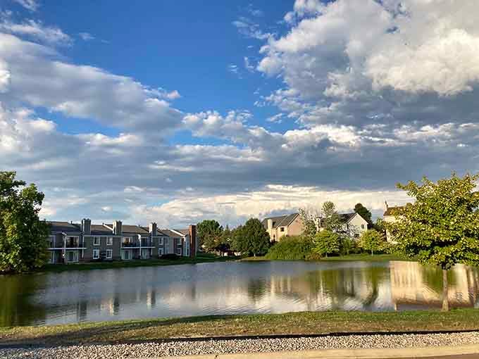 Peaceful waters mirror dramatic clouds in this Farmington Hills neighborhood, where nature and suburban comfort shake hands daily.