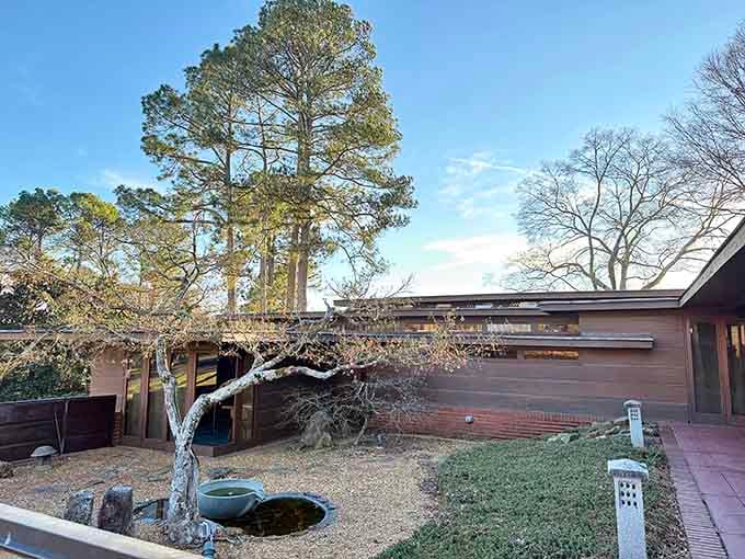 The horizontal lines and natural materials of this architectural gem blend seamlessly with the surrounding landscape.