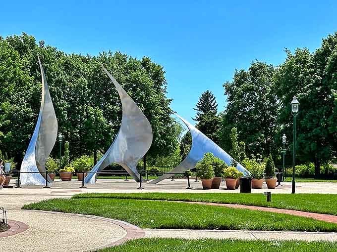 Those striking metal sculptures catch the light, adding modern artistry to the lush gardens surrounding them.