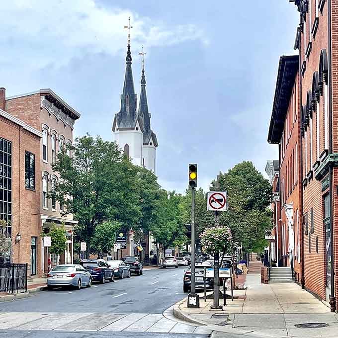 Twin church spires pierce the sky above tree-canopied streets that look like they're auditioning for a Hallmark movie.