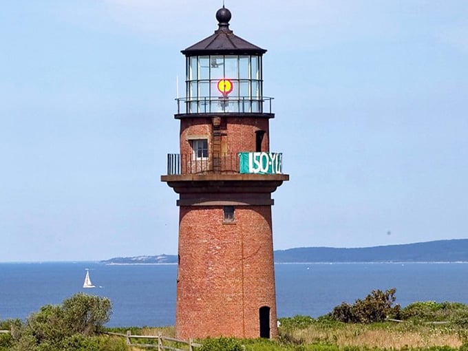 The glowing beacon celebrates its anniversary, still guiding vessels through these historic waters with unwavering dedication.