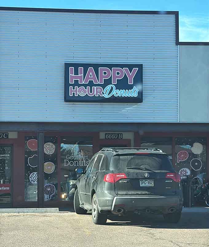 That retro-modern signage glows like a beacon for anyone who believes donuts qualify as legitimate happy hour fare.