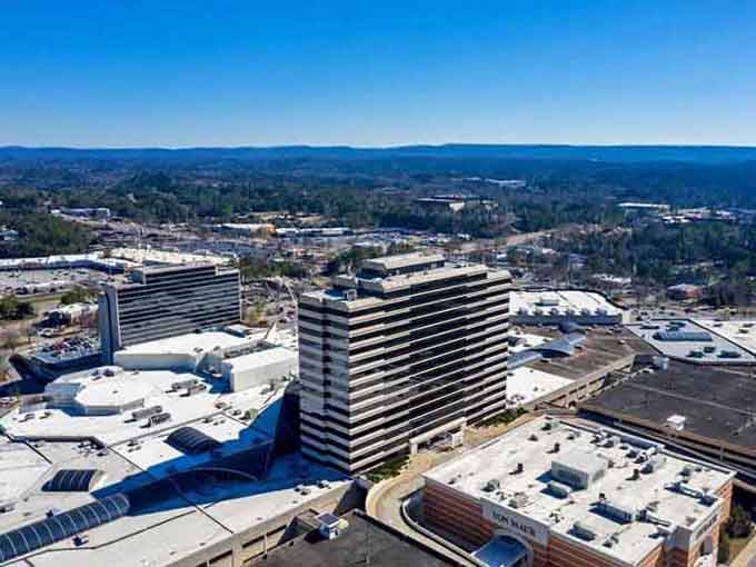 Those striped towers stand like modern sentinels, watching over a city that's mastered the art of comfortable living.