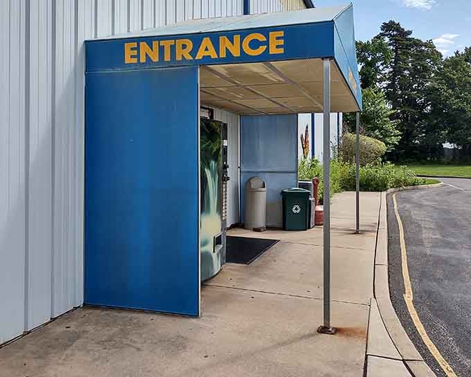 The bright blue entrance beckons the curious, promising a world where insects are celebrated rather than swatted away.