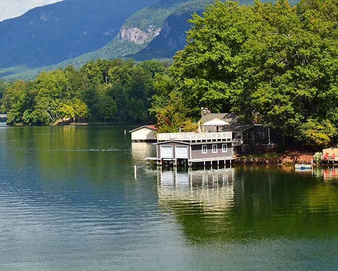 Mountains rise dramatically behind lakeside docks, creating reflections so perfect they'll make your camera work overtime.