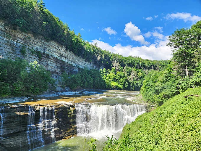 Layered rock walls frame the cascading water perfectly, like nature hired an interior designer with impeccable taste.
