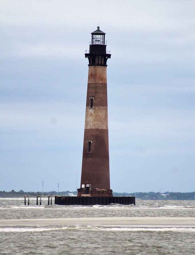 Standing defiant against choppy waters, this striped guardian shows the timeless strength of coastal engineering and determination.