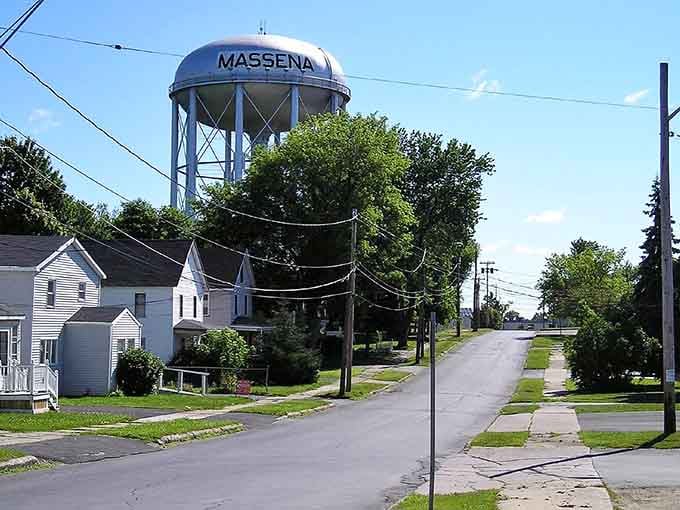 That water tower announces the town name like a beacon, visible for miles and declaring civic pride to anyone passing through.