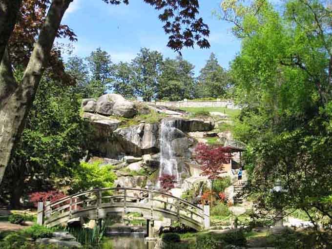 The Japanese garden's arched bridge and cascading waterfall create a scene so peaceful you'll forget you're in the city.