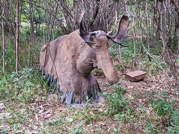A moose sculpture nestled among trees brings woodland magic to life with rustic, earthy authenticity.