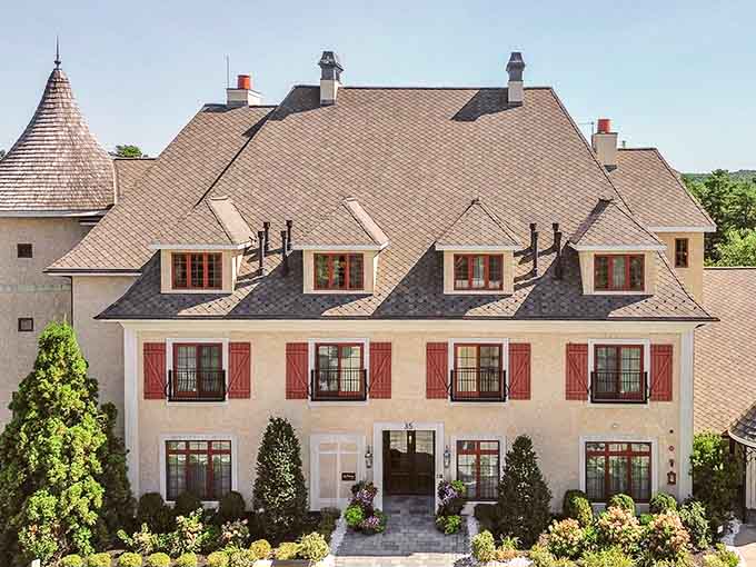 Red shutters and cream stucco walls transport you straight to a lazy afternoon in Provence.