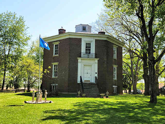 Surrounded by rolling green lawns and split-rail fencing, this unique eight-sided structure resembles a Victorian-era puzzle box come to life.