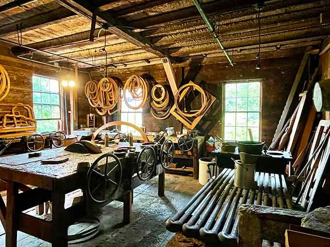 Antique machinery and wooden frame molds hanging overhead showcase craftsmanship techniques that modern factories have long since abandoned.