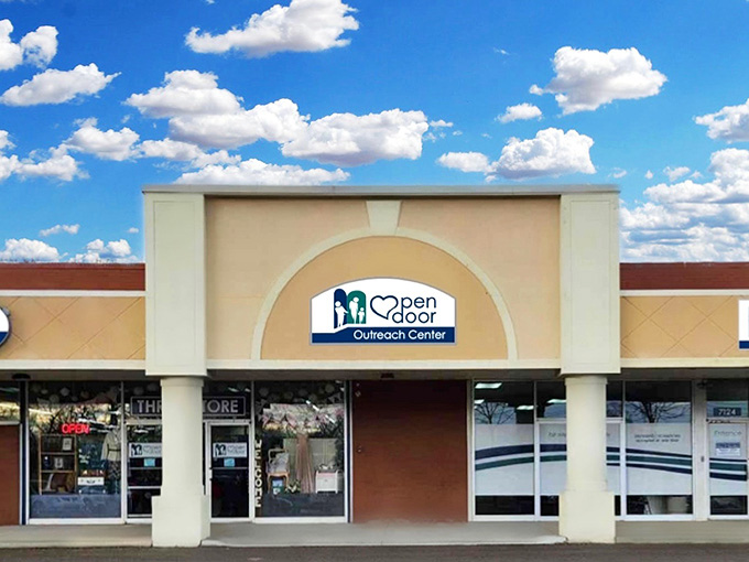 Fluffy clouds drift overhead while this welcoming storefront promises deals that'll make your wallet smile wide.