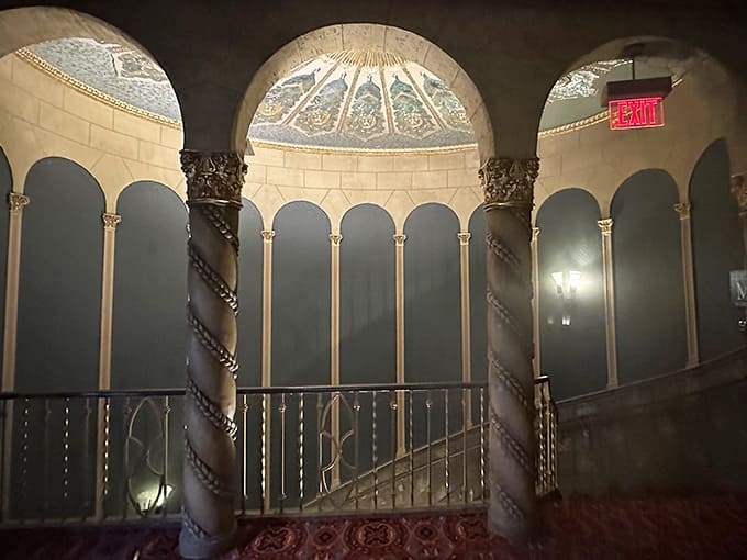 Ornate columns and graceful arches frame the elegant staircase where theater-goers once climbed to their balcony seats in style.