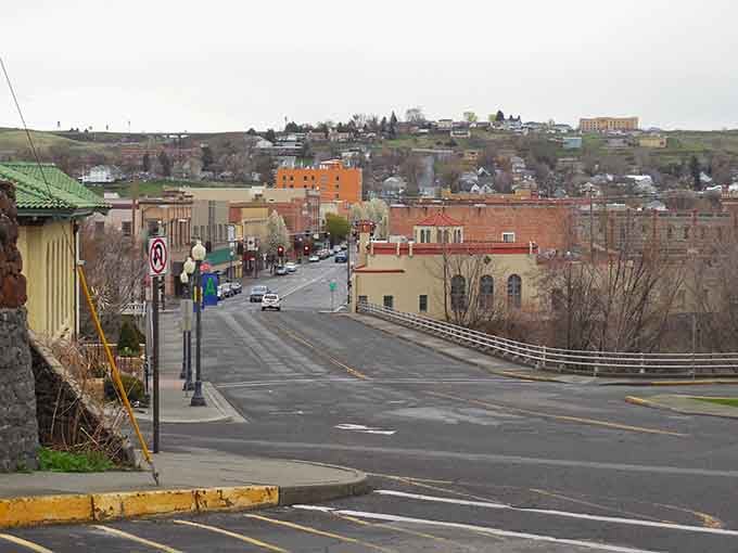 Hills rise behind downtown like natural amphitheater seating for watching your retirement savings actually last through the month.