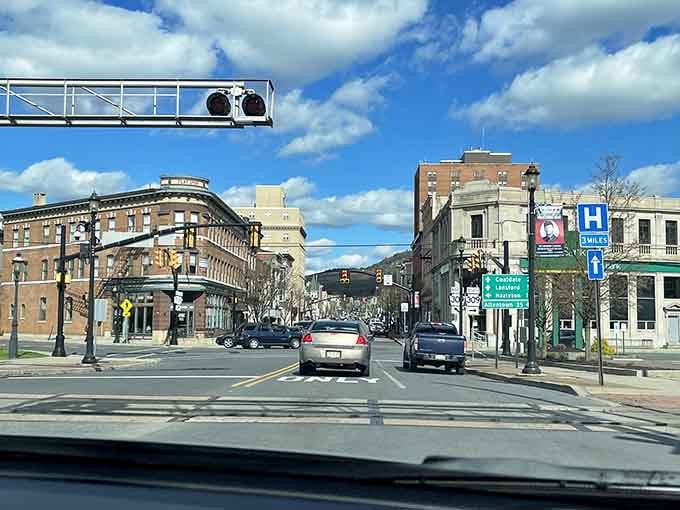 Driving through reveals a mountain backdrop framing everyday life, where nature and neighborhood blend seamlessly together in perfect harmony.