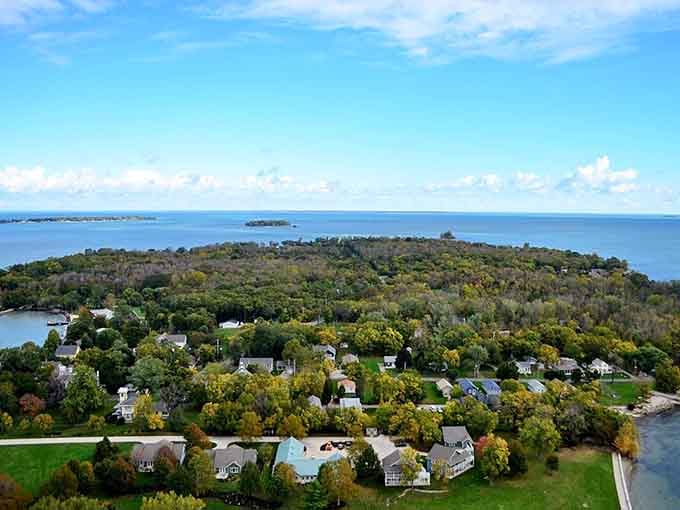 Island living meets Lake Erie's endless blue horizon, where homes nestle among trees like a watercolor painting.