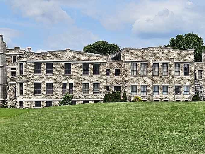Rows of windows punctuate these fortress walls, standing as silent witnesses to decades of stories within these imposing stones.