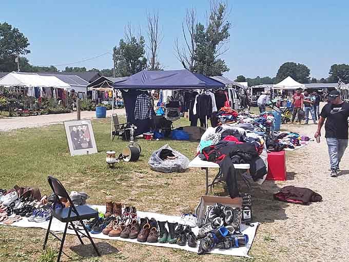 Shoes arranged in neat rows on folding tables catch the sunlight while clothing piles promise hidden gems for patient browsers.