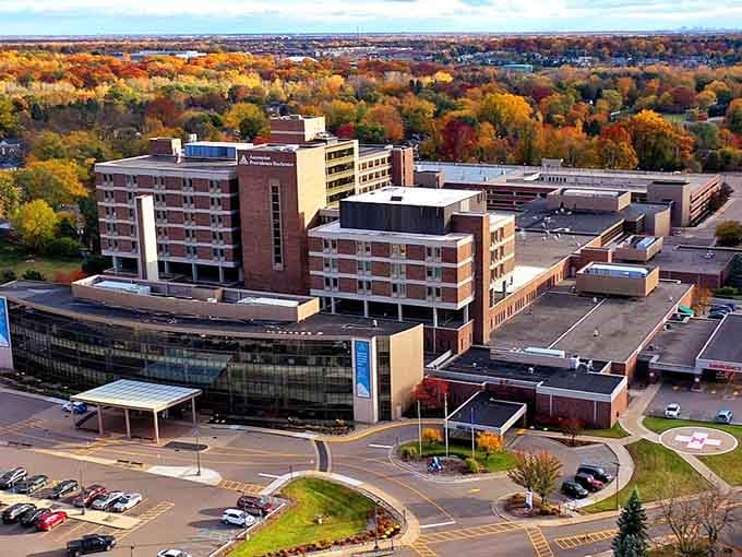 Fall foliage explodes across the landscape, turning ordinary rooftops into a patchwork quilt of autumn brilliance.