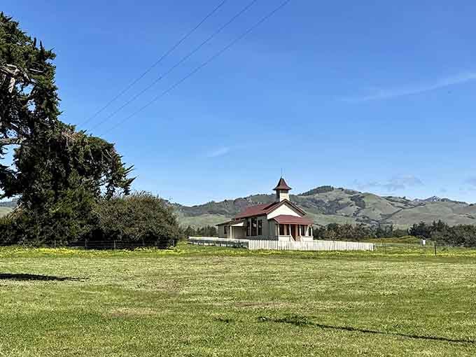 This peaceful red schoolhouse sits in emerald fields where California's ranching history still feels wonderfully alive today.