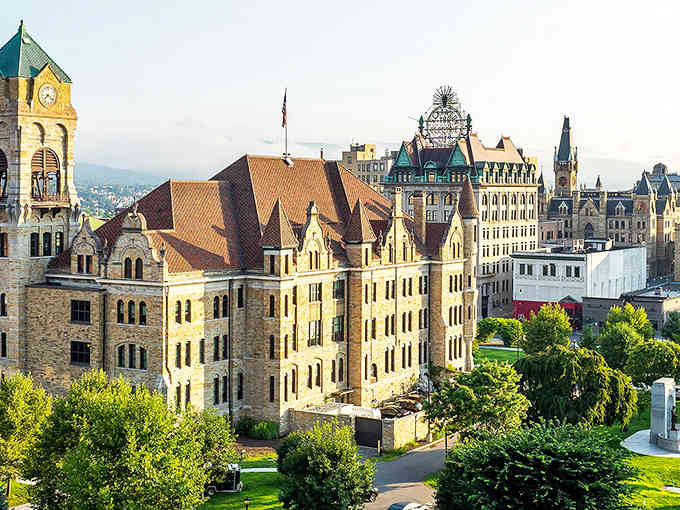 The bird's-eye view reveals a city nestled in green valleys, proving nature and urban life can coexist.