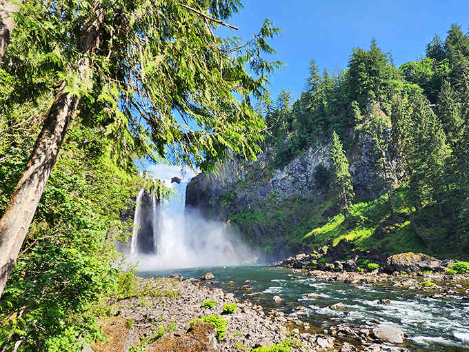 The base of the falls reveals rushing water and rocky shores perfect for feeling nature's raw power.