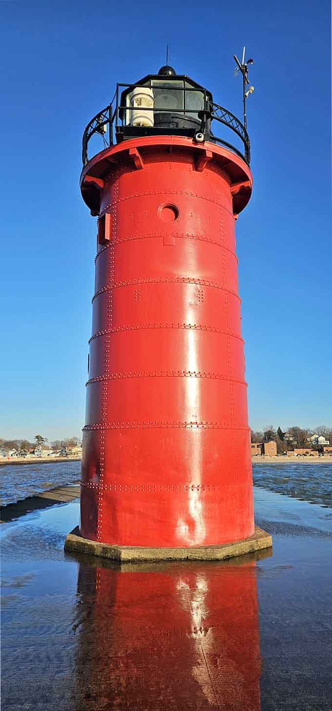 Up close, those rivets and red paint gleam like a classic car, reflecting perfectly in the calm harbor waters.