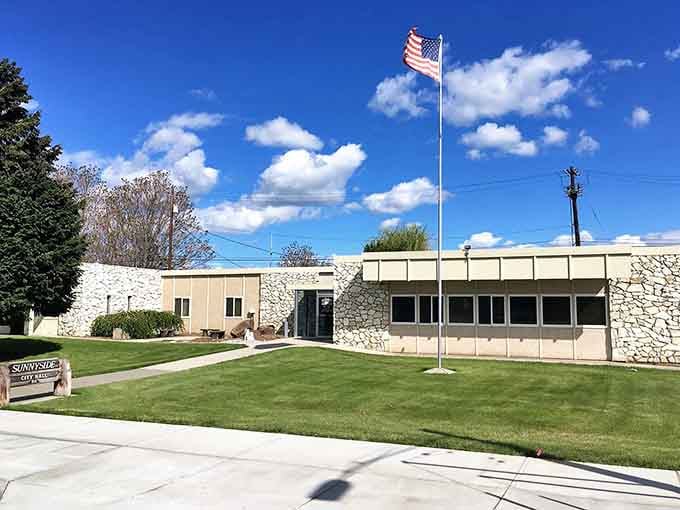 The flag waves proudly over manicured lawns and clean pathways, showing a community that takes real pride in itself.