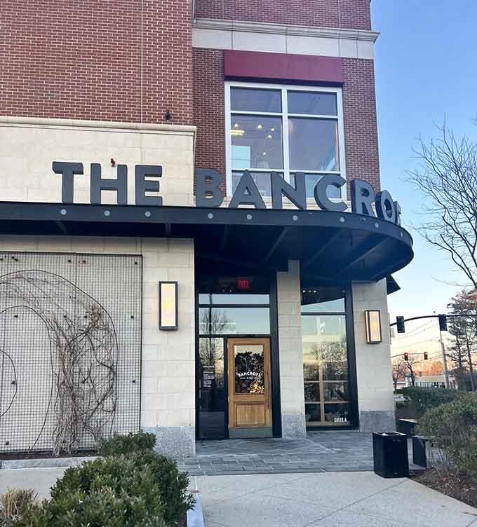 That curved entrance canopy beckons like a theater marquee, promising dinner theater where beef plays the starring role.