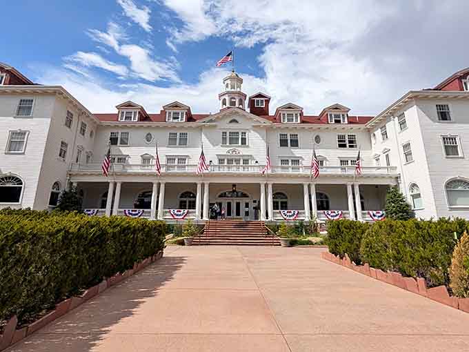 The patriotic bunting and manicured walkway welcome guests to this iconic mountain resort's elegant entrance.