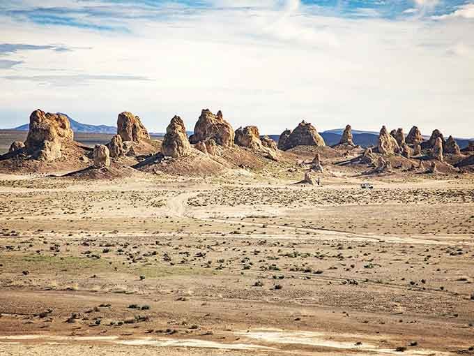 Golden hour transforms these ancient formations into glowing towers, standing sentinel over the empty desert like patient guardians.