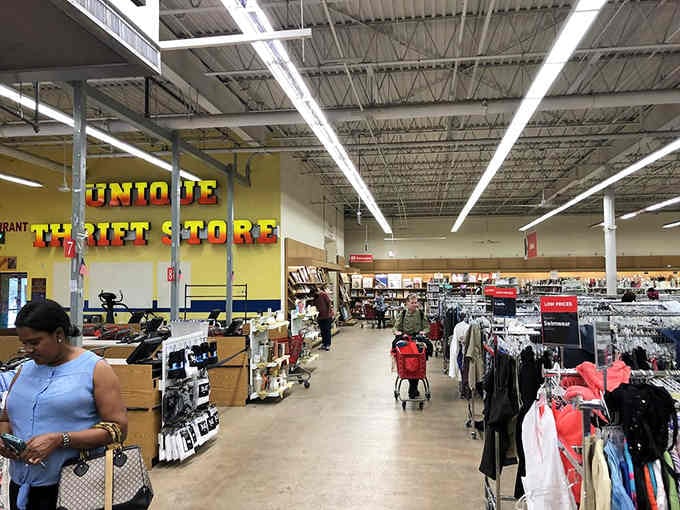 Bright overhead lighting illuminates aisles of possibilities where yesterday's fashion becomes tomorrow's favorite outfit at fraction prices.