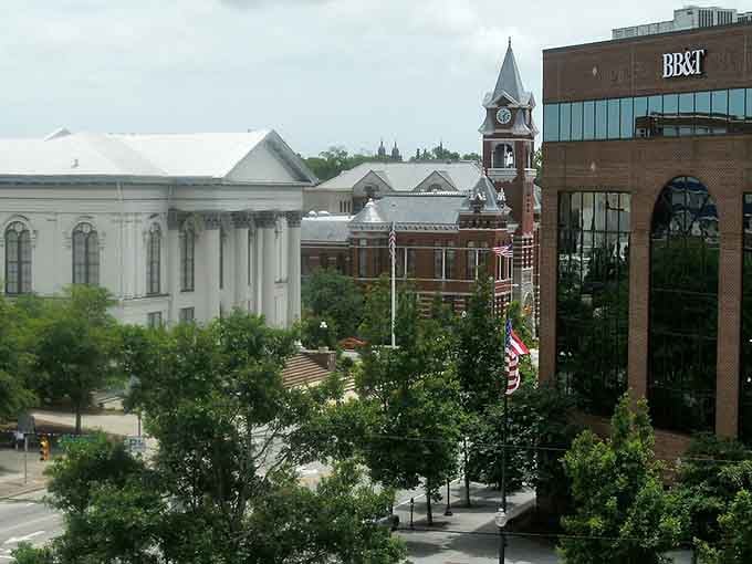 Historic clock tower and modern architecture share the frame, proving that different generations can live together quite nicely.