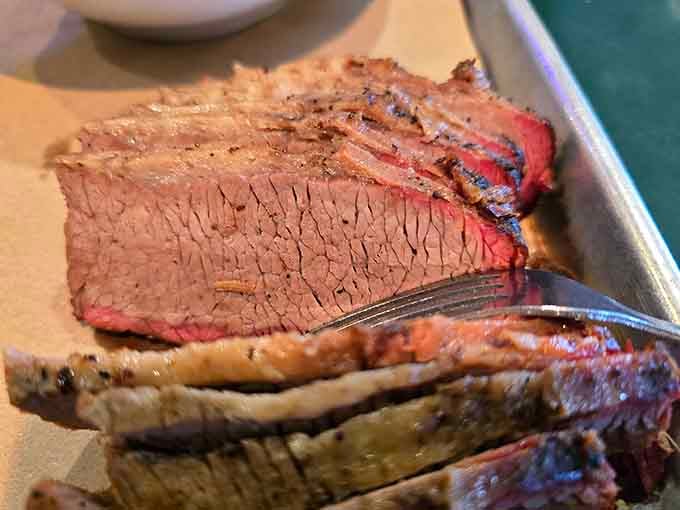 That perfect smoke ring and pink center prove patience and skill created this brisket masterpiece.
