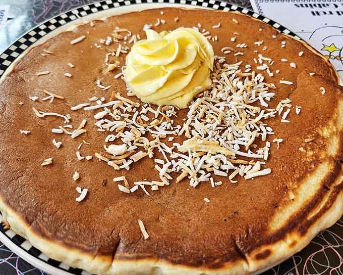 Pancakes topped with butter and coconut shavings prove that breakfast can be both simple and spectacular.