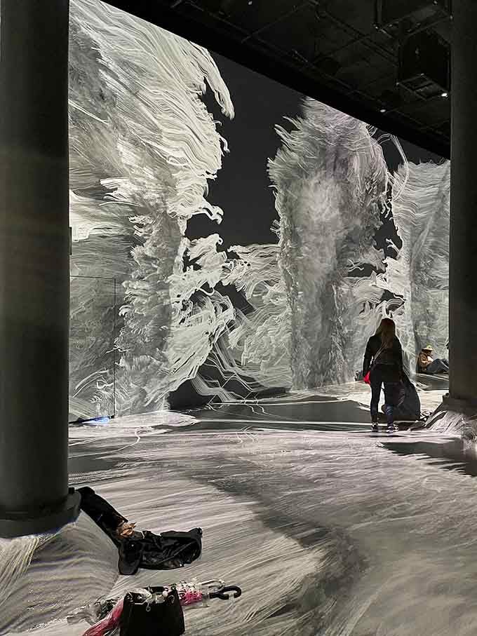 Thread sculptures catch light like frozen waterfalls, creating shadows that dance better than most wedding guests.